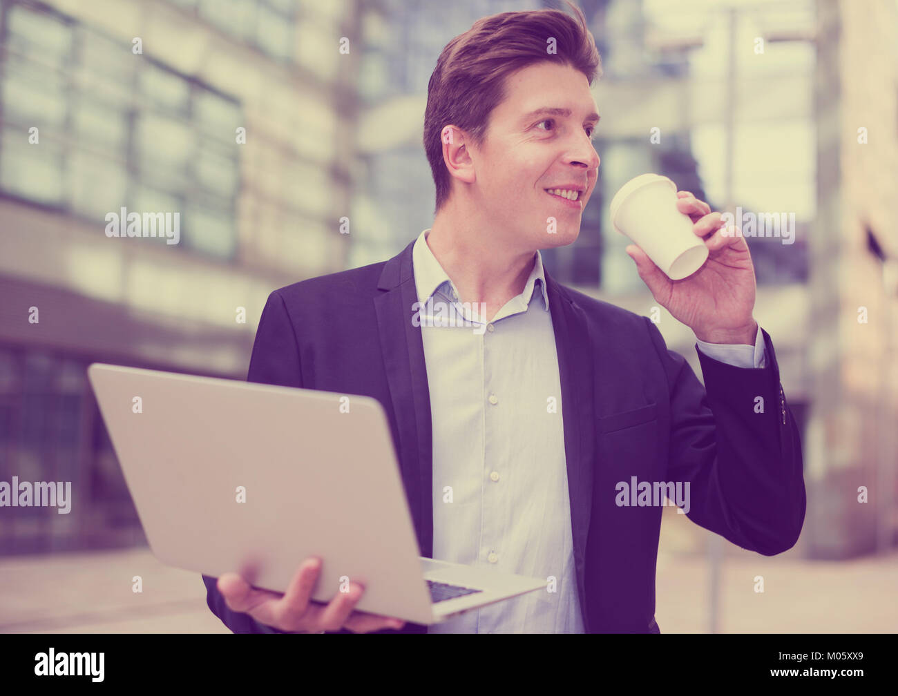 Professional worker drinking coffee and working at the notebook Stock ...