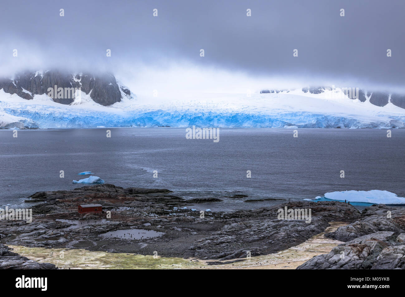 Rocky coastline fjord panorama with mountains, clouds and blue glacier ...