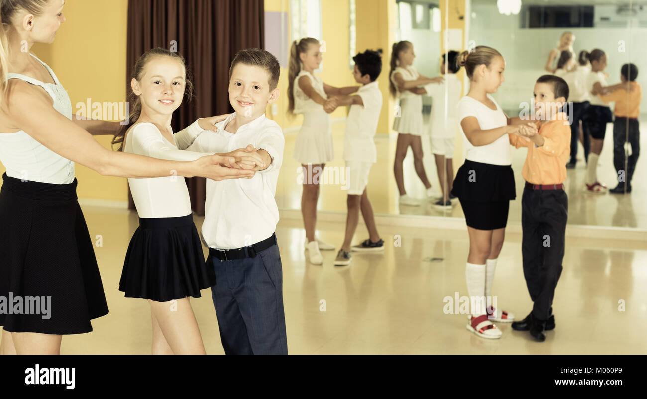 Group of diligent positive children dancing tango in dance studio Stock ...