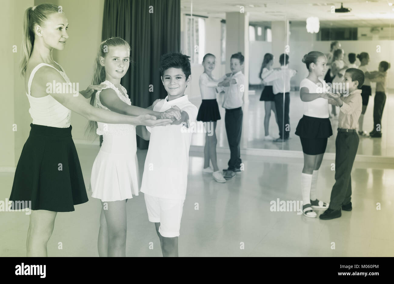 Teacher is demonstrating to kids how to dance tango in class Stock ...