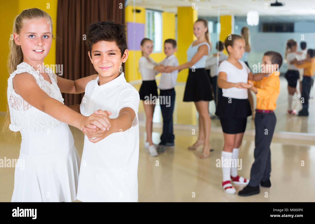 Kids are dancing tango in class Stock Photo - Alamy
