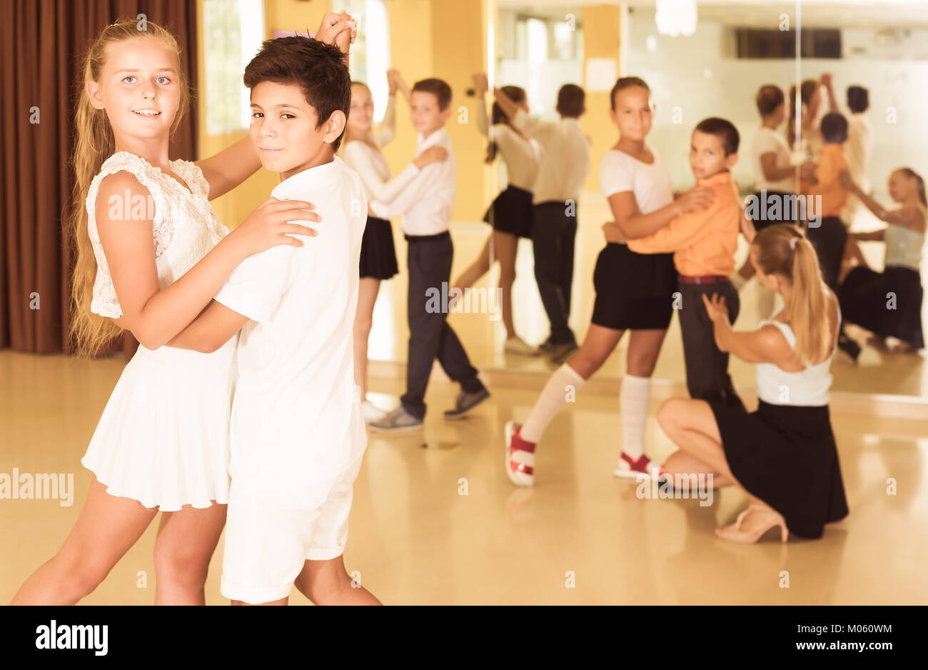 Active young children enjoying of partner dance in class Stock Photo ...