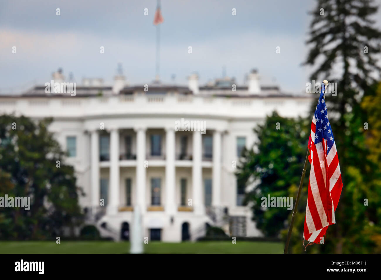 The American flag of a tourist standing in front of the White House in ...