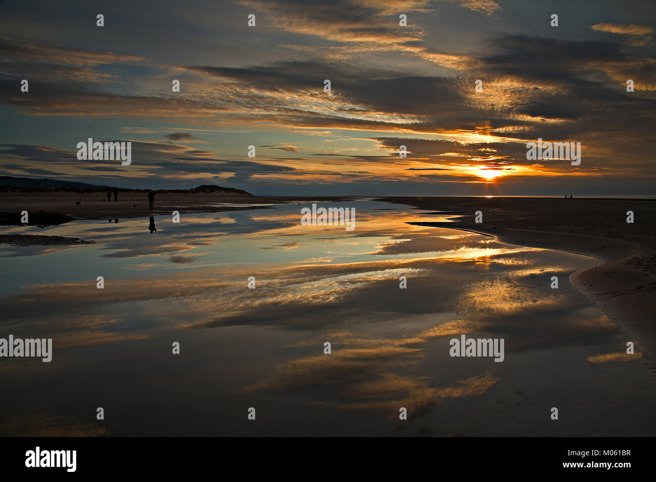 Clouds at sunset reflecting in pool on beach at Talacre on the North ...