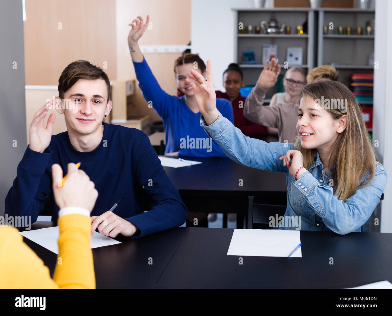 Girls and boys in class are ready to give answer to teacher’s question ...