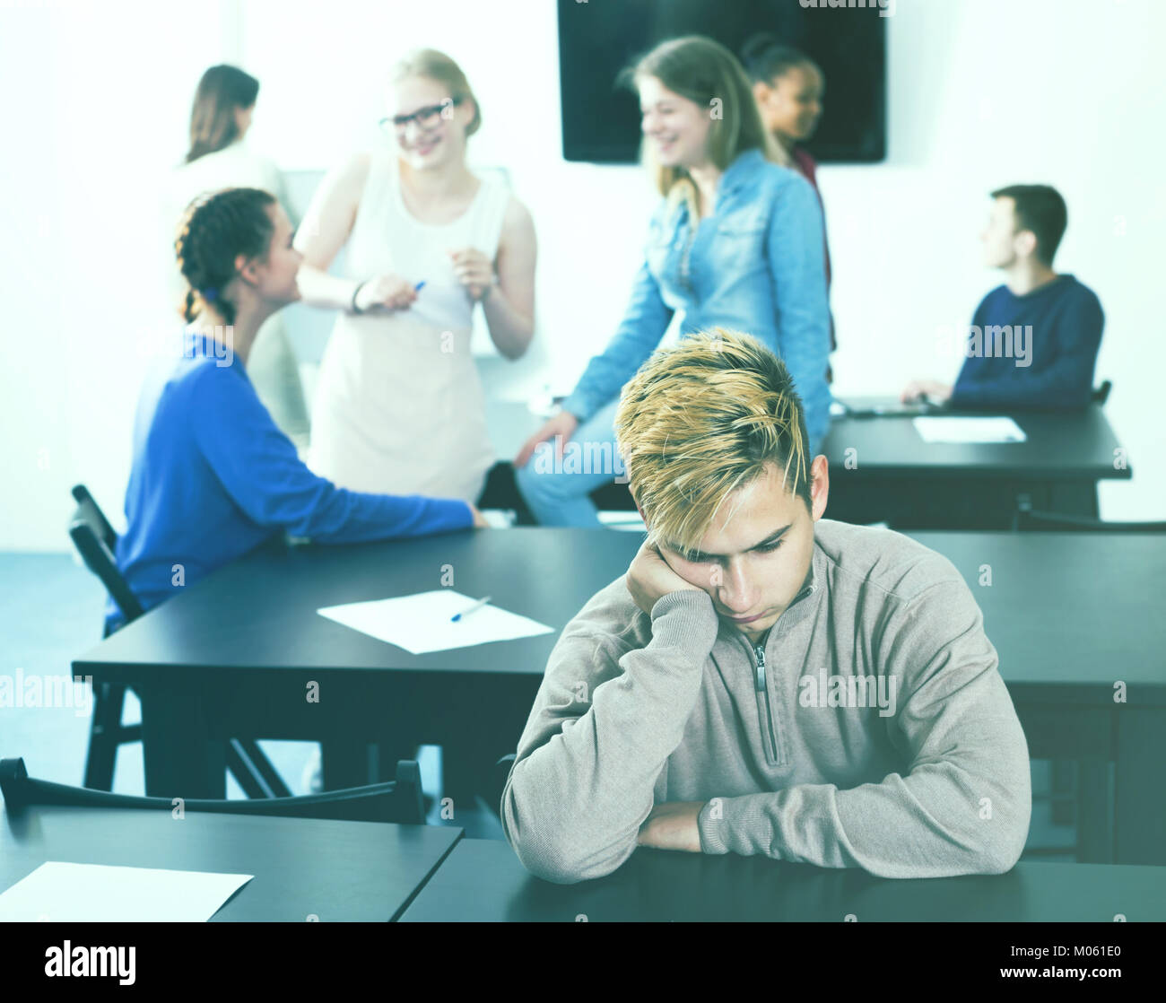 Young new boy student being shy among classmates at recess in school ...