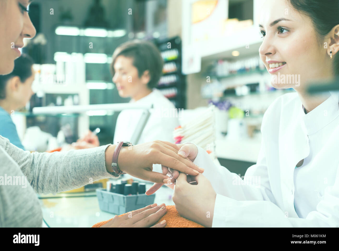 Nail technicians performing manicure procedure in beauty salon Stock ...