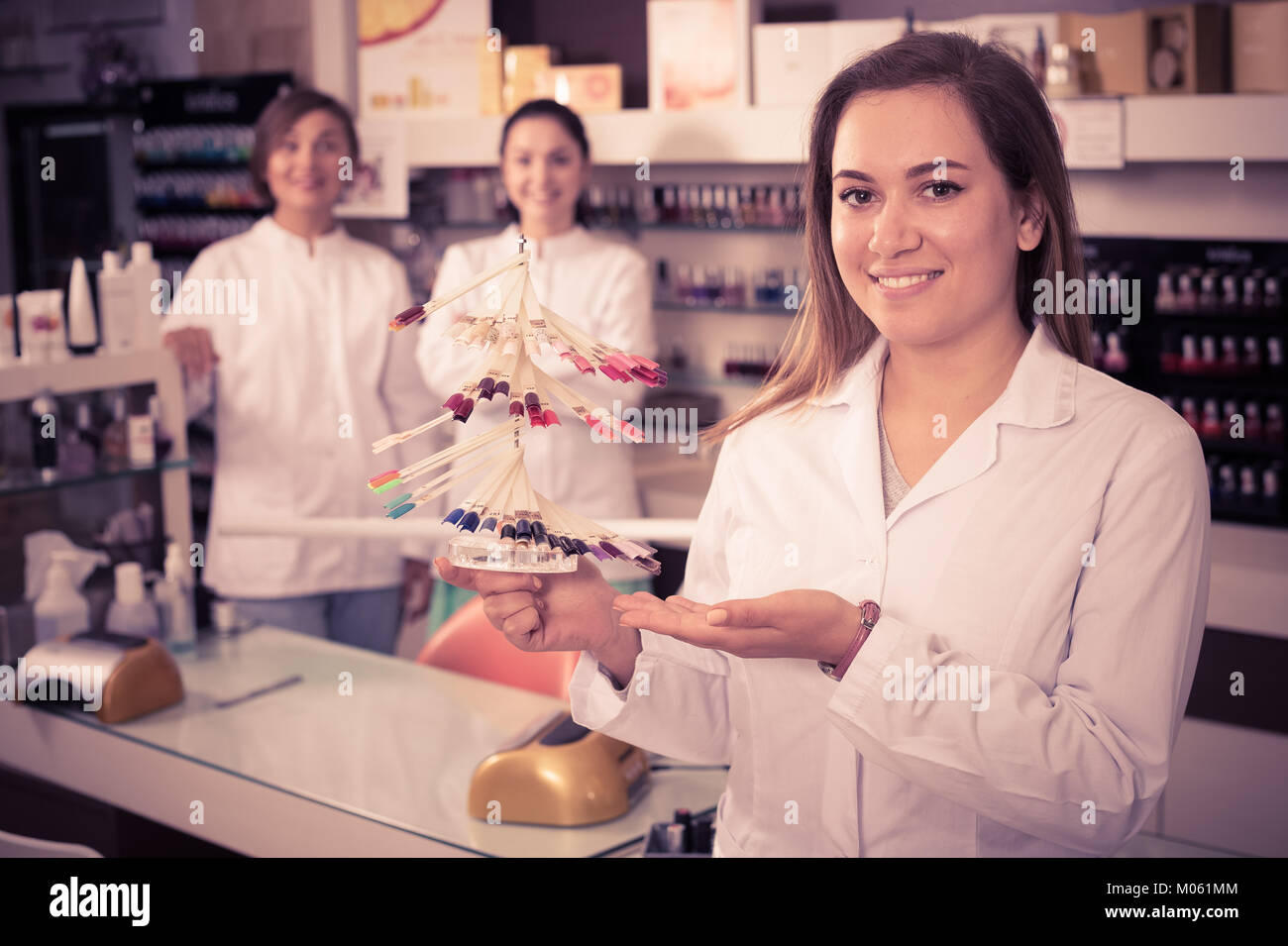 Manicurists showing diversity of nail varnish in salon Stock Photo - Alamy