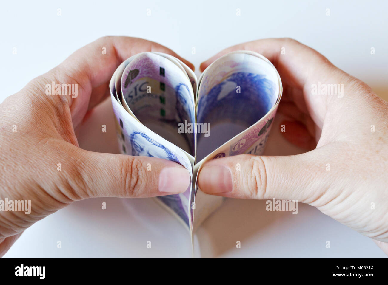 Czech paper money in a shape of the heart with hands - economy and ...