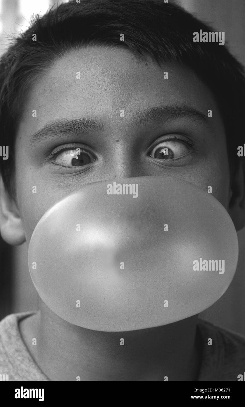 a child makes a balloon with a bubble gum Stock Photo - Alamy