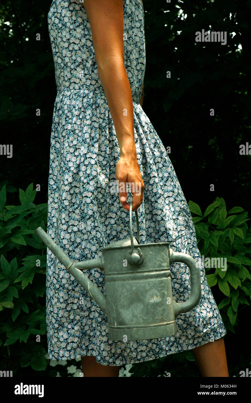 woman with watering can Stock Photo - Alamy