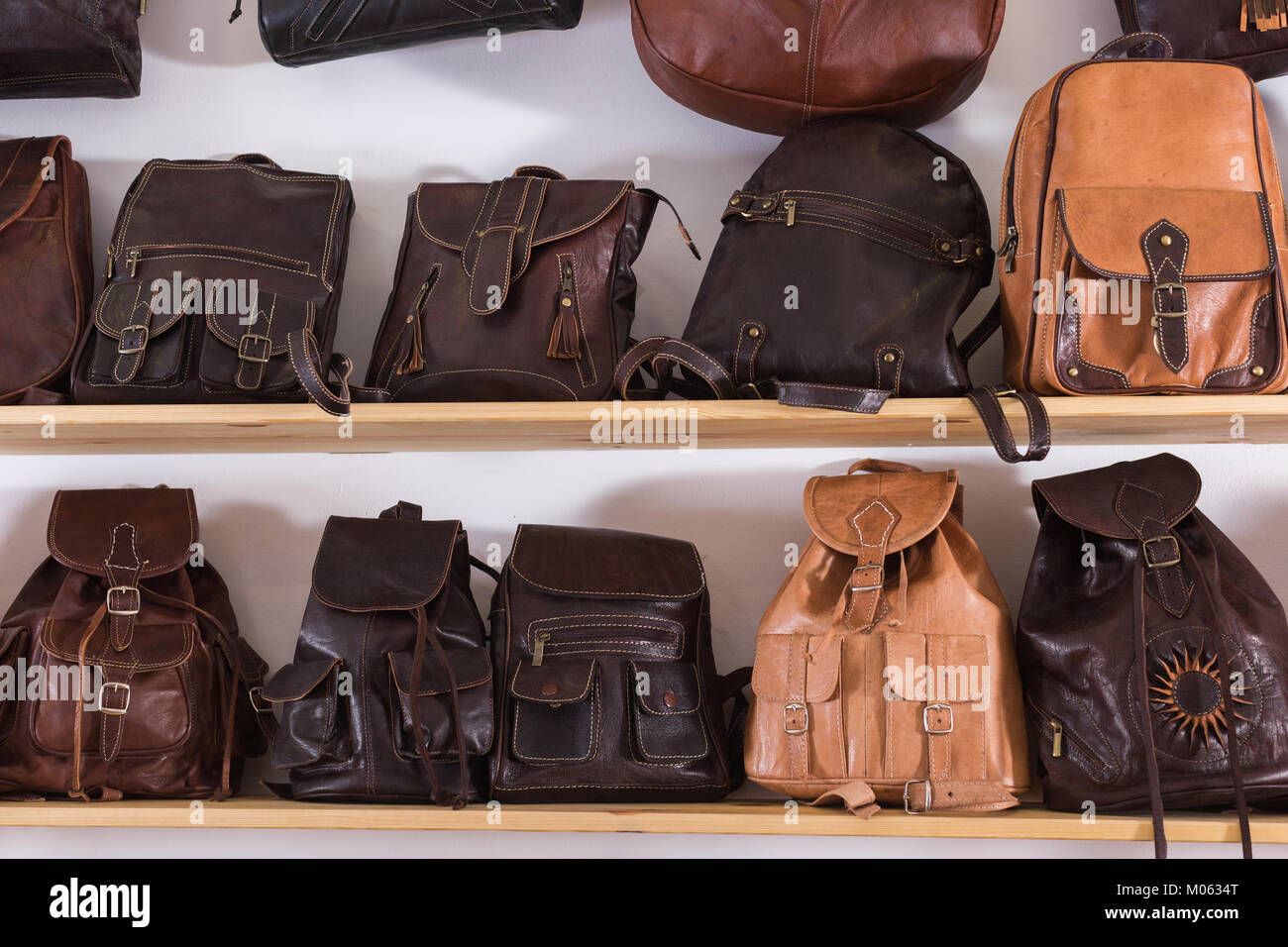 Handmade leather backpacks and bags on shelf in european shop Stock ...