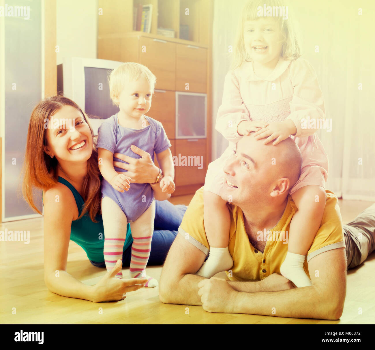 parents with two children at home interior Stock Photo - Alamy