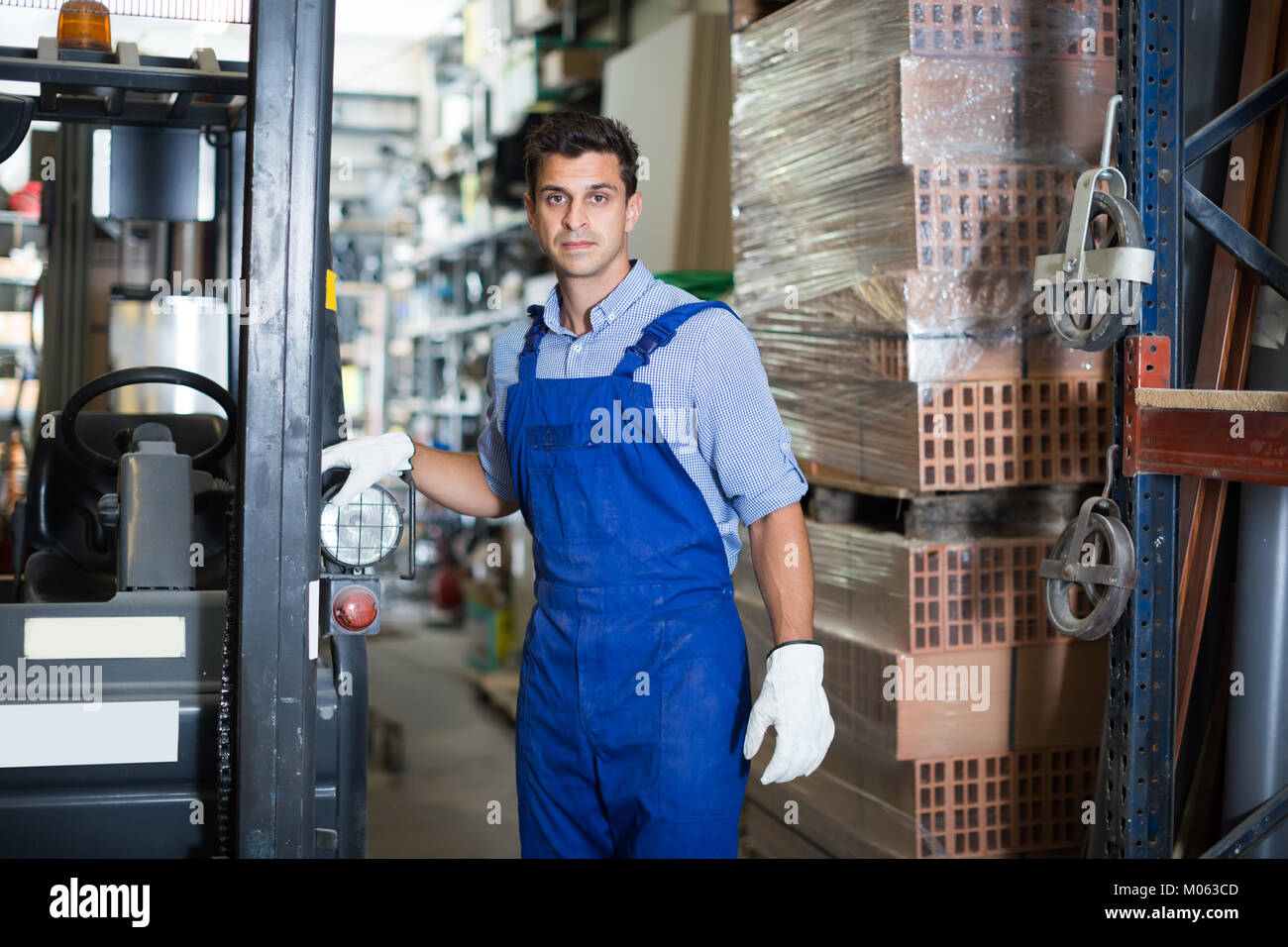 Portrait of foreman in uniform on his workplace in building store Stock ...