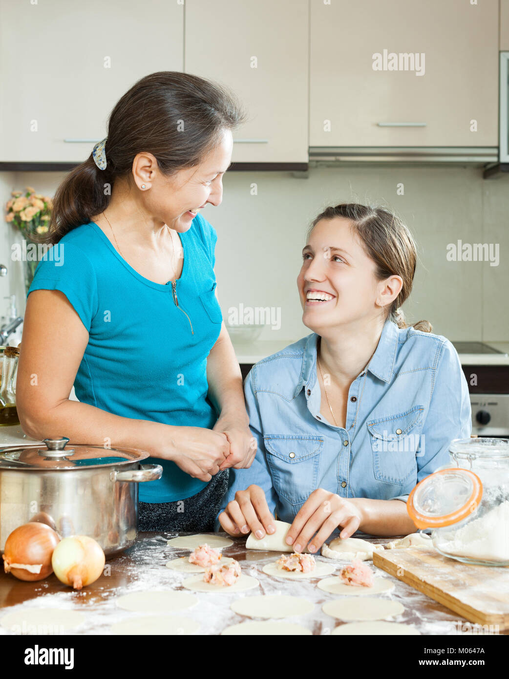 women cooking meat dumplings together at home Stock Photo - Alamy