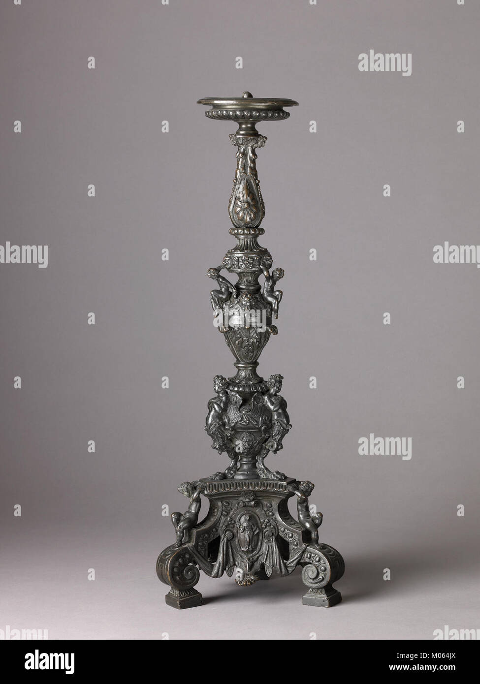 This 18th-century candlestick, supported by putti (cherubic figures ...
