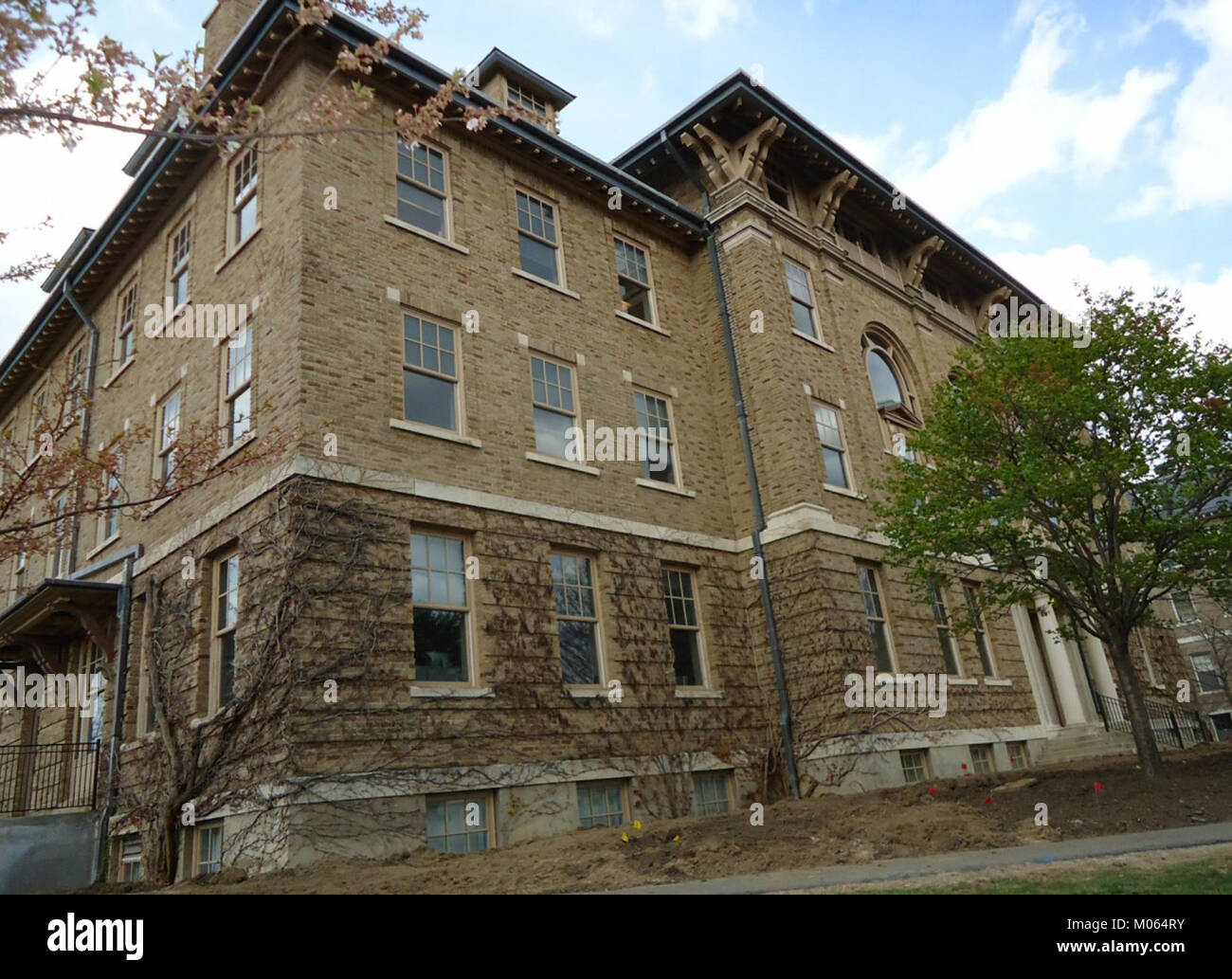 The image depicts a building at Cornell University, showcasing ivy ...