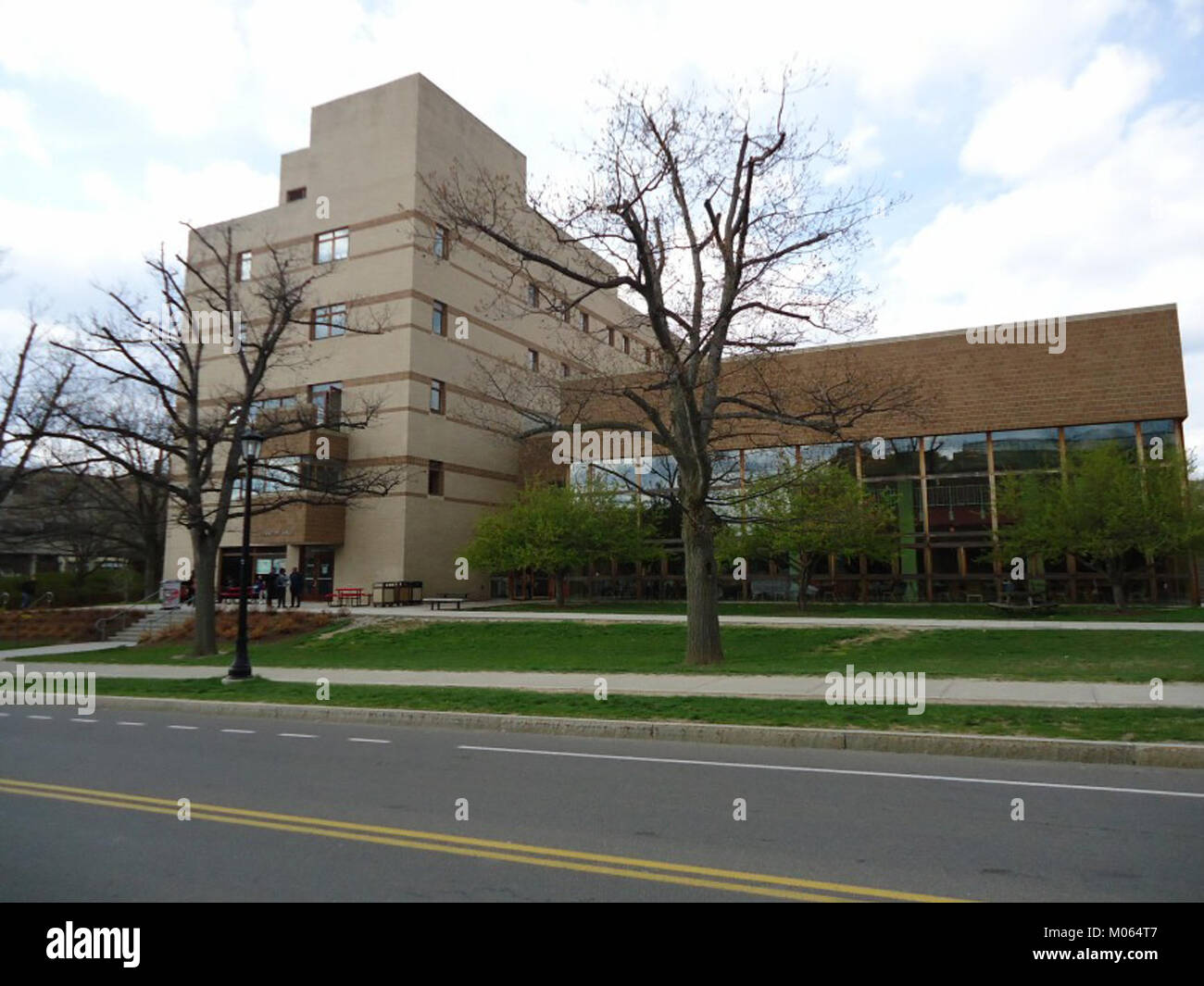 This image depicts a campus building situated behind a street at ...