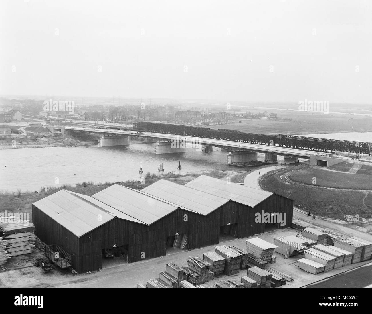 This image depicts the construction of a bridge over the Maas River ...