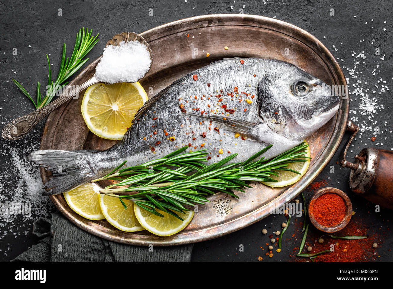 Fresh raw dorado fish with ingredients for cooking. Top view Stock ...