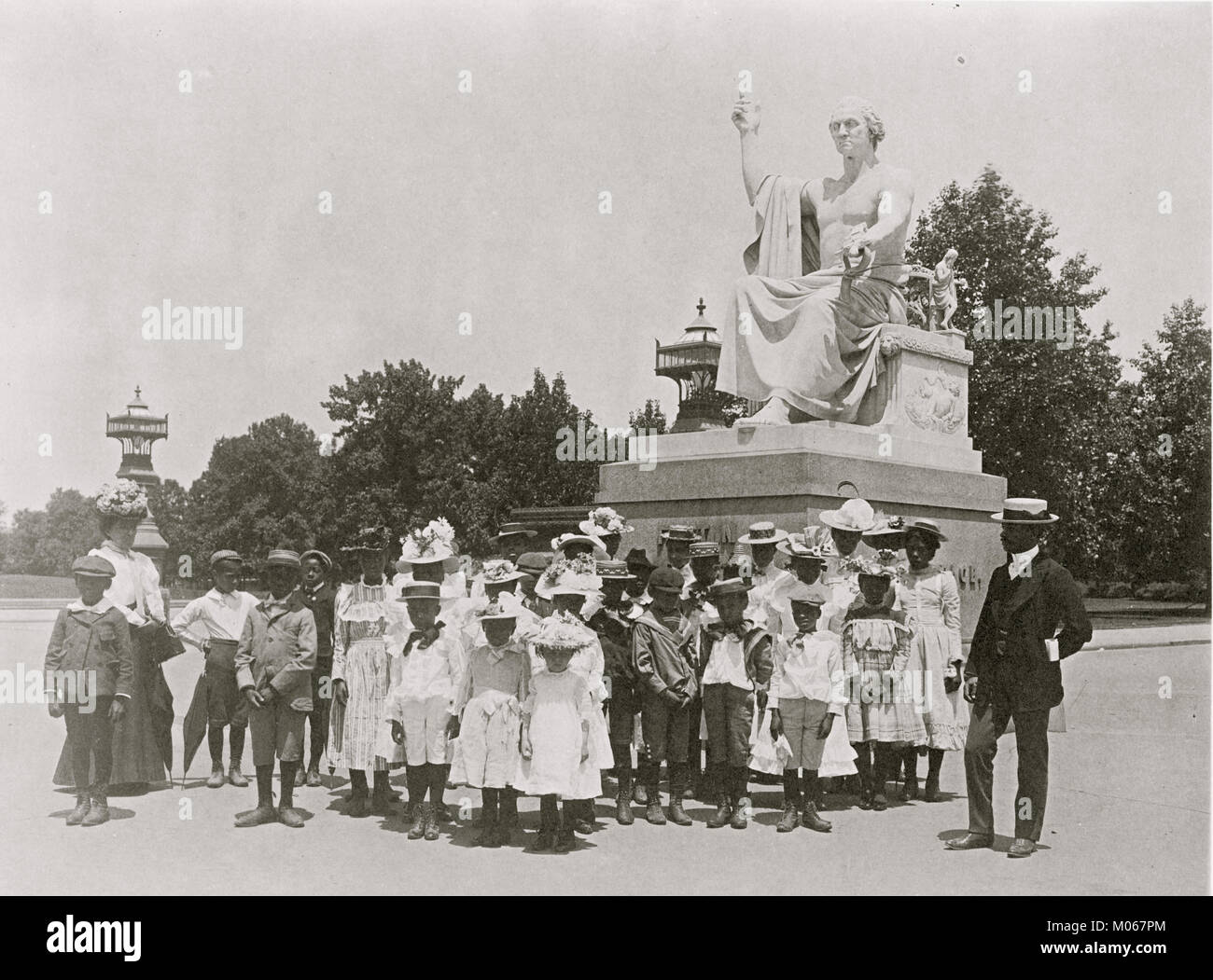 Group of school children in front of statue of George Washington ...