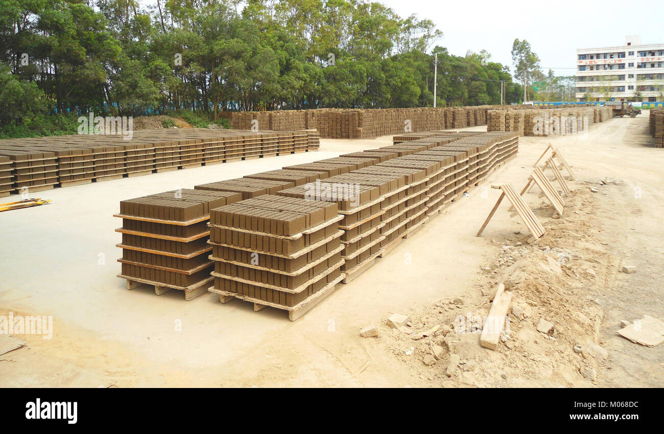 The image shows a brickworks site in Hainan, highlighting the drying ...