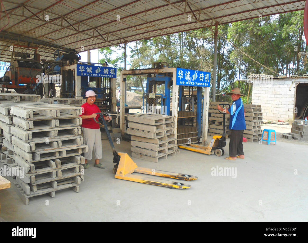 This photograph depicts the labor-intensive process of brickmaking at a ...