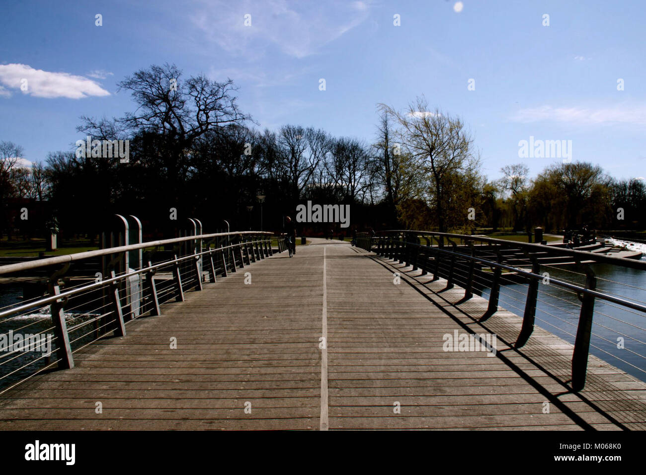 This photograph or artwork captures a bridge spanning the Odense River ...
