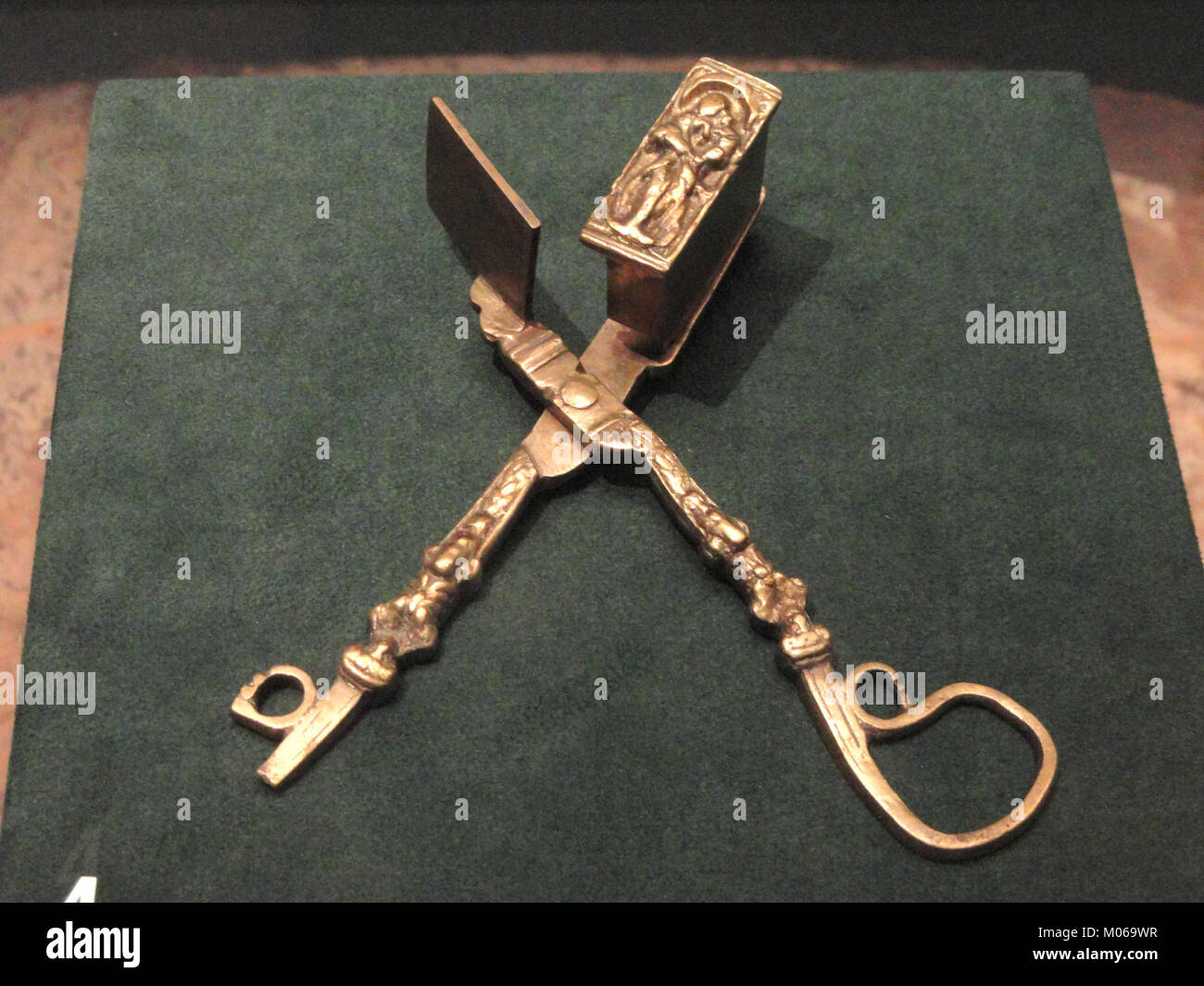 This 17th-century brass candle snuffer is a functional yet decorative ...