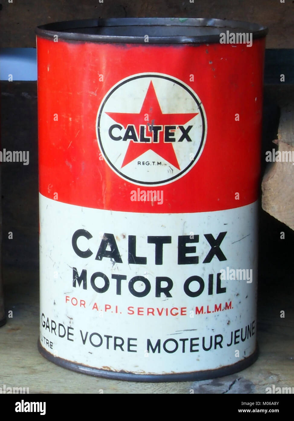 This advertisement for Caltex Motor Oil features the phrase 'Garde ...
