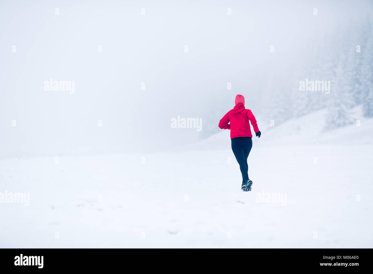 Girl running on snow in winter mountains. Sport, fitness inspiration ...