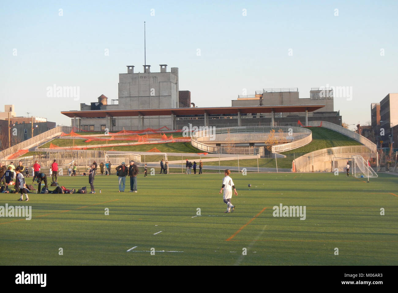This photograph captures a soccer game at Bushwick Park, illustrating ...