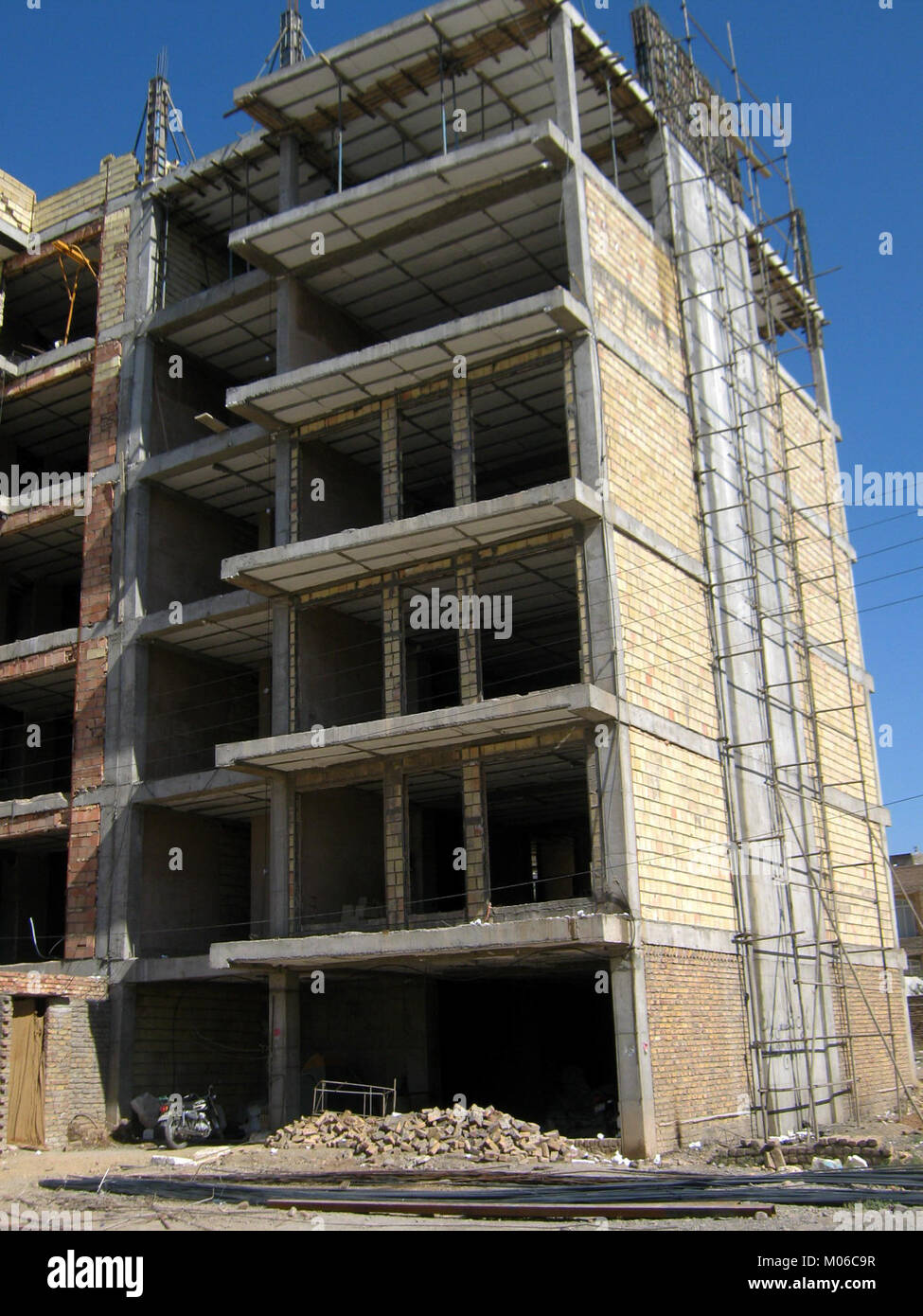 A photograph depicting a building under construction on Molla Sadra Boulevard in Nishapur ...