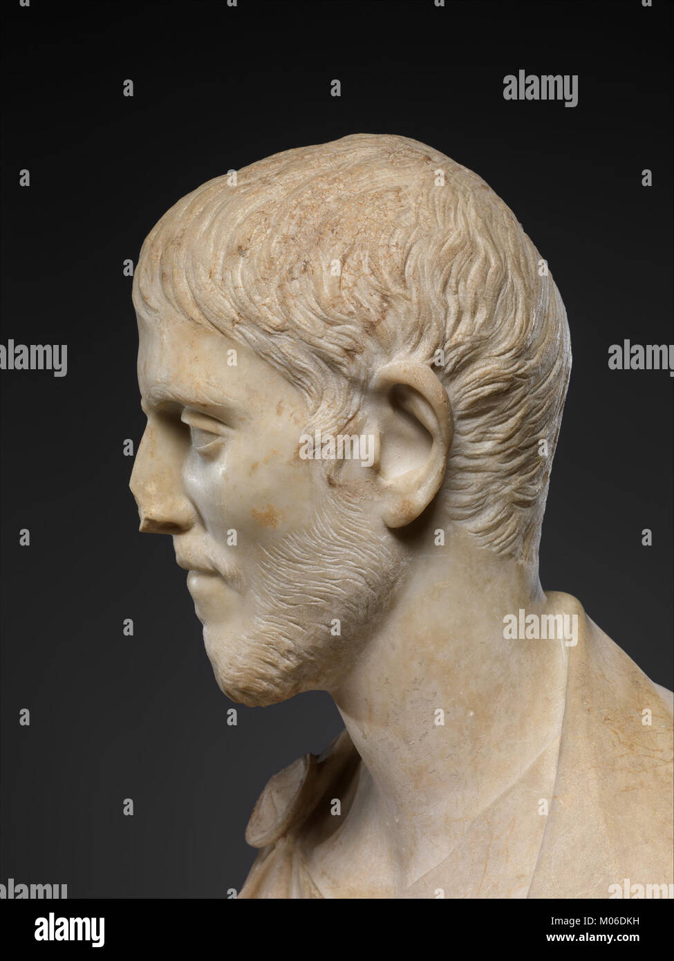 This marble portrait bust represents a male figure, crafted with ...