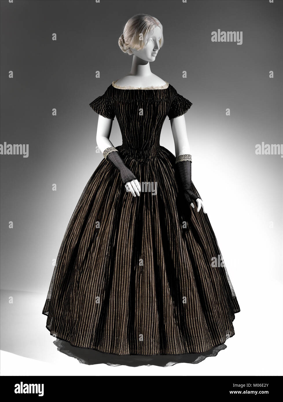 A mourning dress from the 19th century, made of dark fabric, typically ...