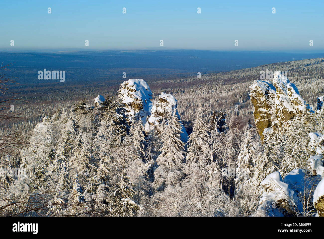 View from the top of the Ural ridge on a clear winter day on wooded ...