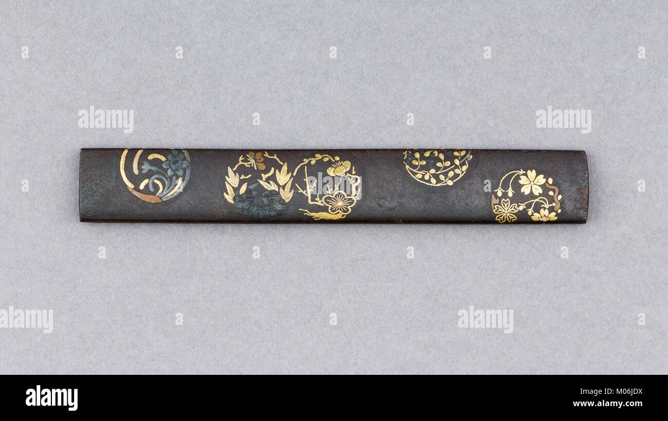 This knife handle (Kozuka) is a finely crafted piece, showcasing ...