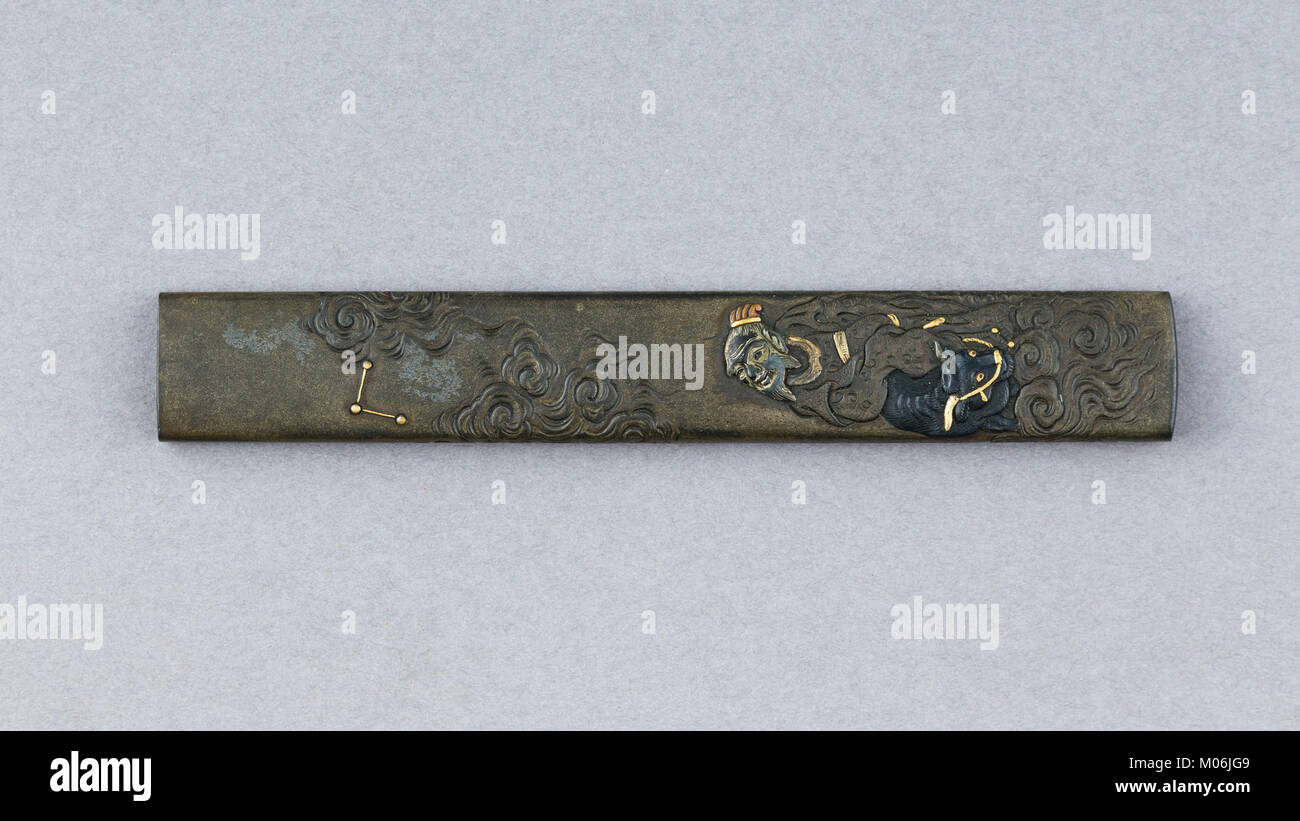 This kozuka knife handle, from Japan, is intricately designed, with ...