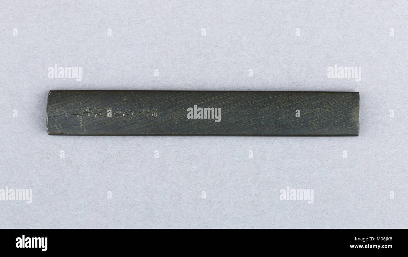 This knife handle, or kozuka, is a detailed ornamental object ...