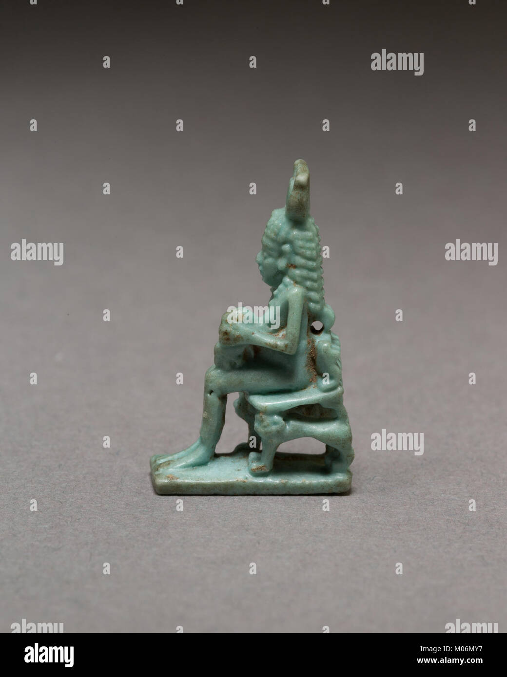 This sculpture shows the goddess Isis nursing the infant Horus while ...
