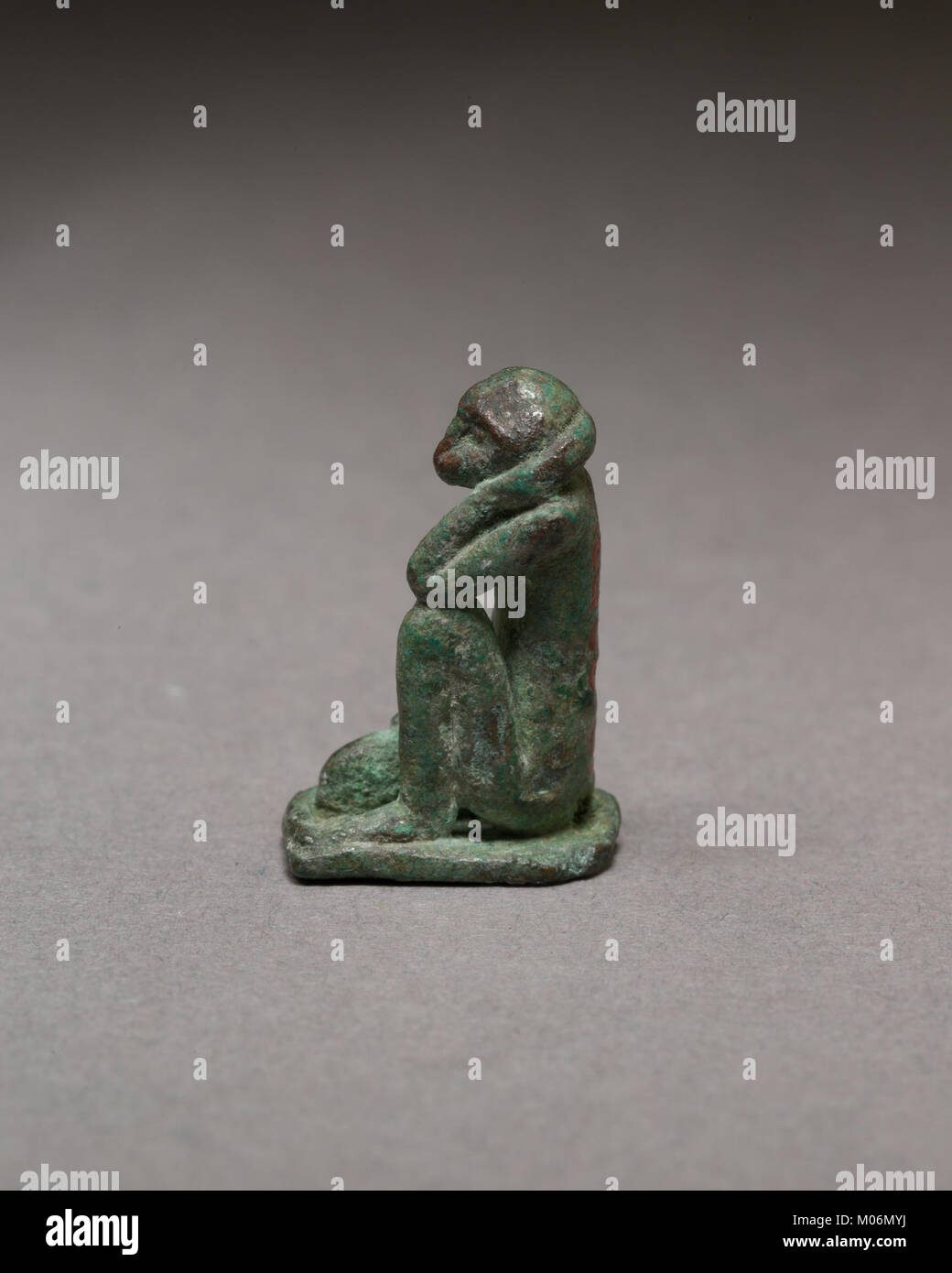 This artwork depicts a monkey kneeling with its head resting in its ...