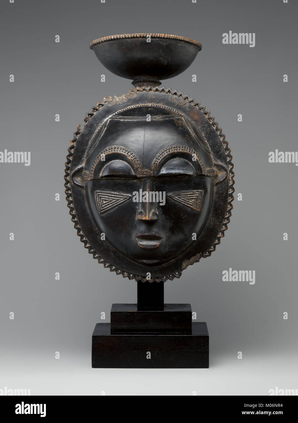 A moon mask, showcasing intricate design work typical of its cultural ...