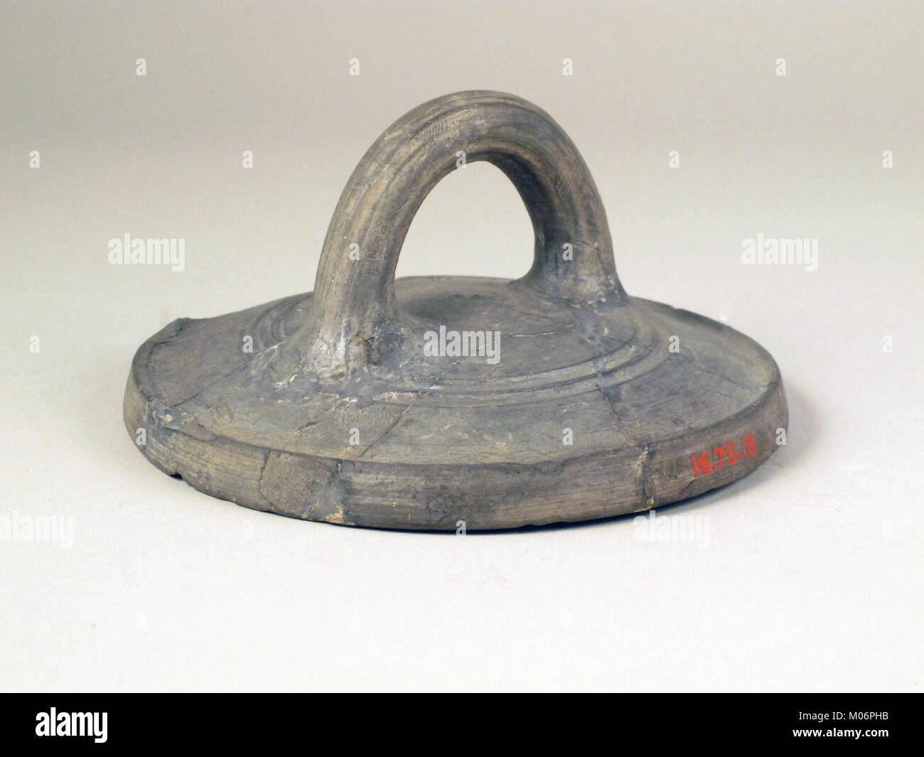 This lid, part of a vase, is an important artifact, showcasing detailed ...