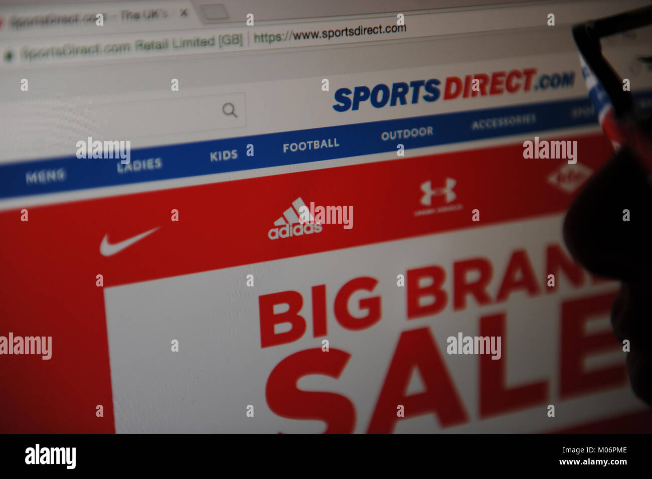 A woman looks on the Sports Direct website Stock Photo - Alamy
