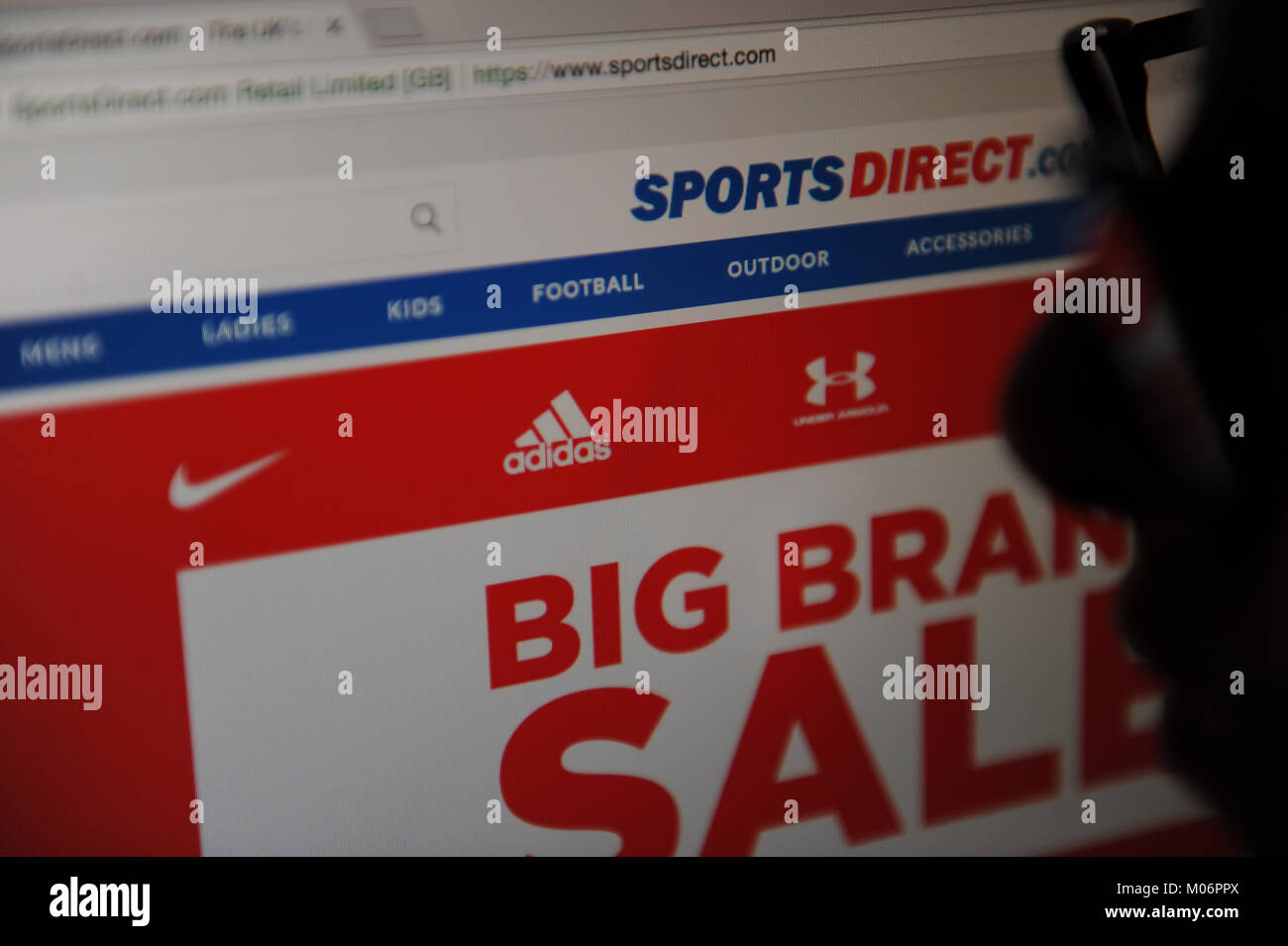 A woman looks on the Sports Direct website Stock Photo - Alamy