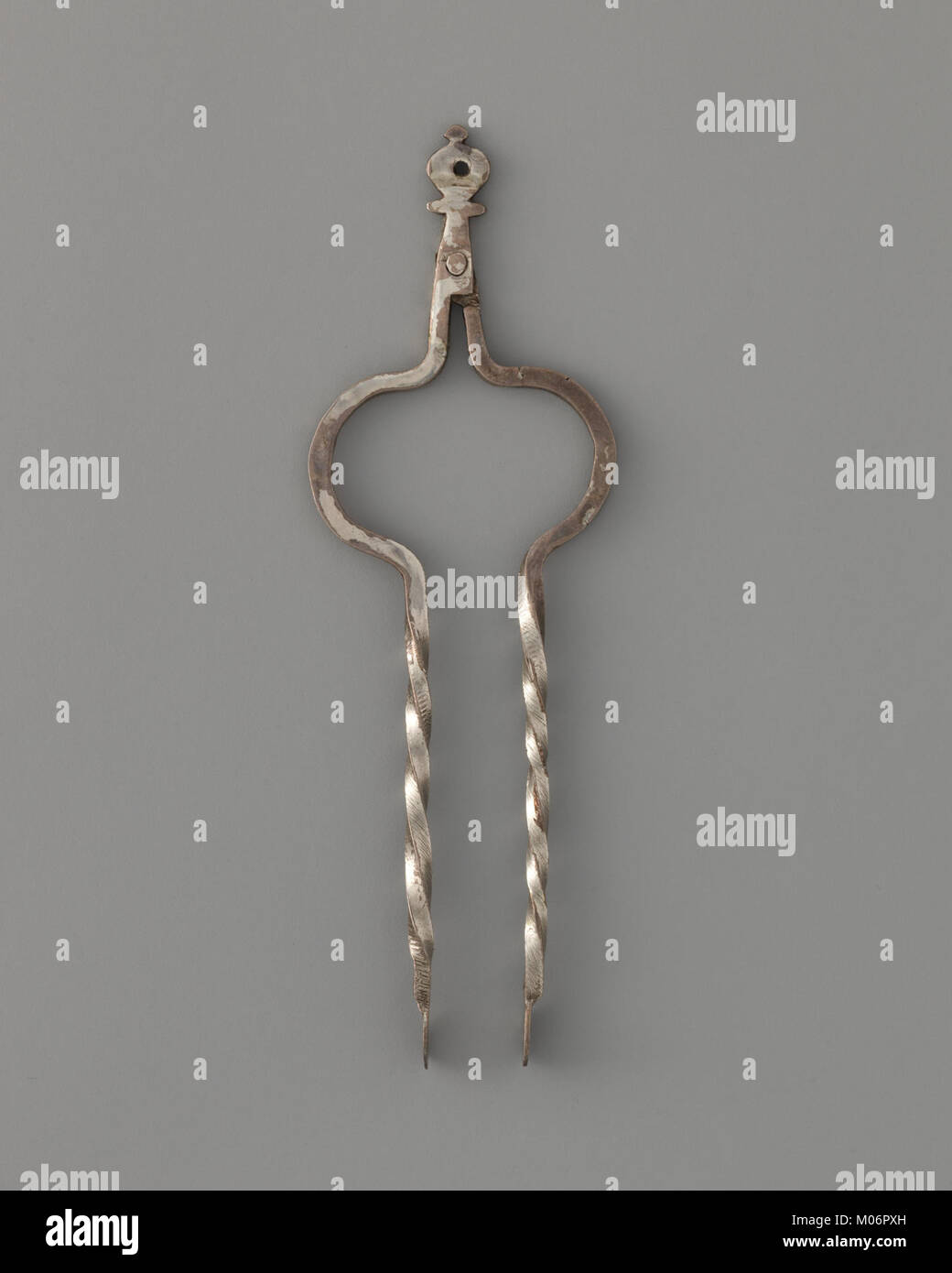 These miniature tongs are part of a set, showcasing fine craftsmanship ...
