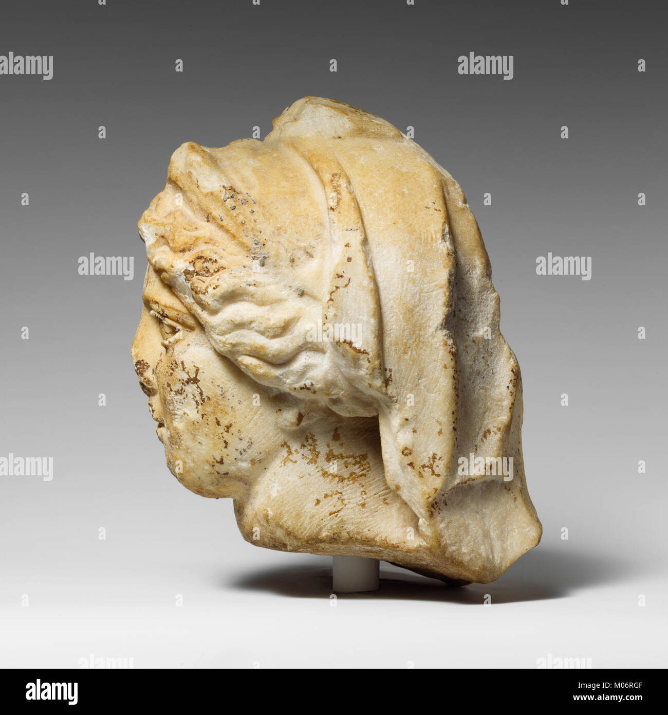 A marble head sculpture of a woman, adorned with a diadem and veil ...