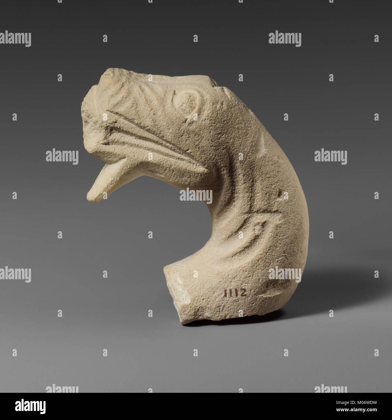 This limestone sculpture represents the head of a snake, showcasing the ...