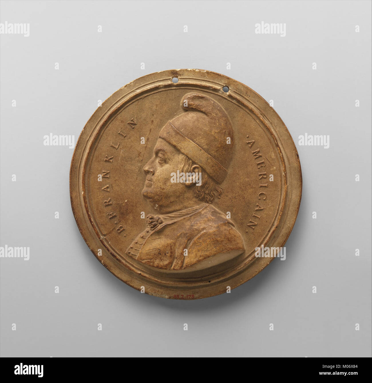 This medallion features intricate designs, likely depicting historical ...