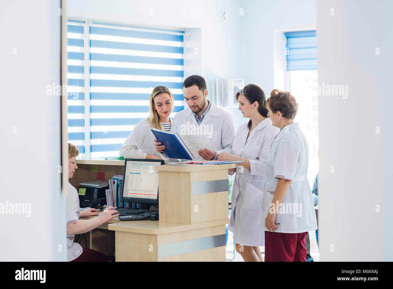 Senior patient talking nurse reception hi-res stock photography and ...